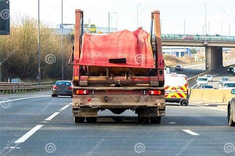 A Large Skip Lorry Carrying A Skip To Or From A Site To Fill Or Empty