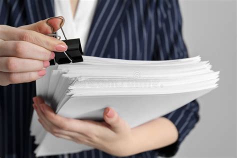 Woman Attaching Documents With Metal Binder Clip On Grey Background Closeup Stock Image Image