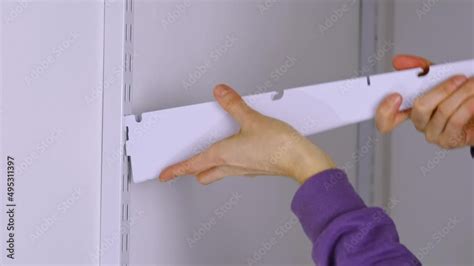 Installation Brackets Of A Metal Mesh Shelf In The Dressing Room System On A Bracket Hands Is