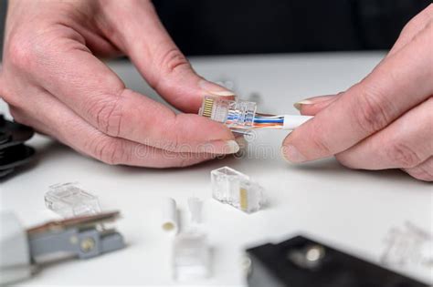 A Woman S Hand Inserts An Internet Cable Into A Clamp Connector Utp Ethernet Network Cable Plug