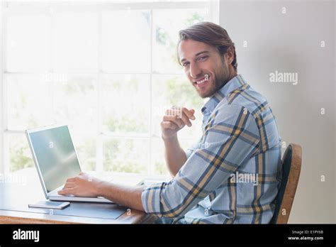 Handsome Man Sitting At Table Using Laptop Stock Photo Alamy