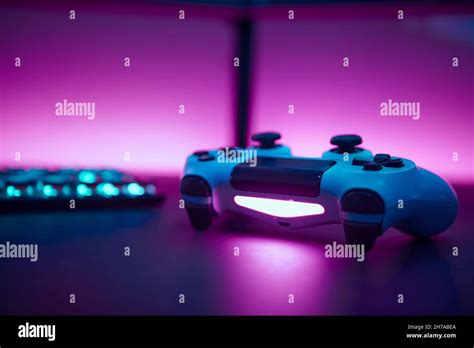 Low Angle View Game Controller On Table Blank Dual Display And Pink