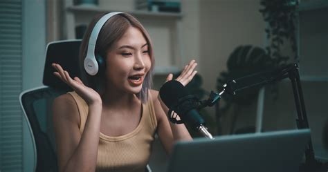 Footage Of Young Asian Woman Influencer Wearing Headphones Talking Into