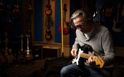 Download Legendary Musician Eric Clapton In His Guitar Collection Room