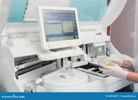 Lab Tech Loading Samples Into A Chemistry Analyzer Royalty Free Stock