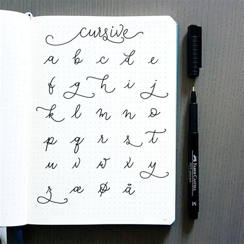 An Open Notebook With Cursive Writing On It And A Pen Next To It