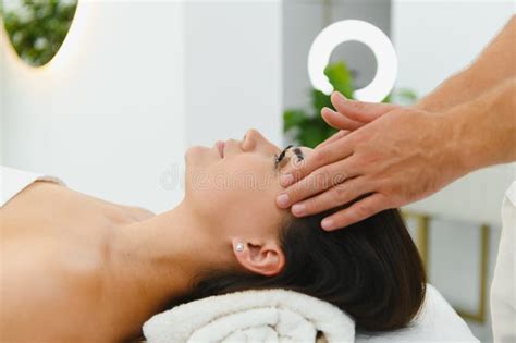 Beautiful Young Girl Having Face Massage In Spa Salon Stock Image