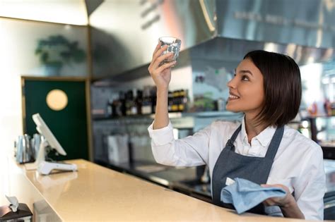 Premium Photo Coffee Shop Assistant At Her Working Place Looking