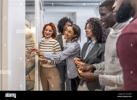 Side View Of A Group Of Colleagues During A Brainstorming Process In A