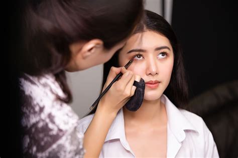 아름다운 젊은 아시아 여성과 전문 메이크업 아티스트는 아이 섀도우를 적용합니다 아름 다운 여자 얼굴입니다 완벽한 메이크업 고객에 대한 스톡 사진 및 기타 이미지 Istock
