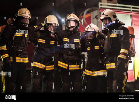 Group Of Professional Firefighters Posing Firemen Wearing Uniforms