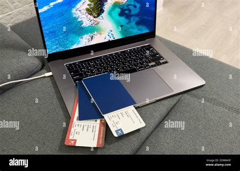 A Passport On Laptop Computer Keyboard Online Travel Booking And Visa