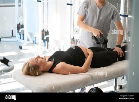 Specialist Physiotherapist Conducts A Myostimulation Session For