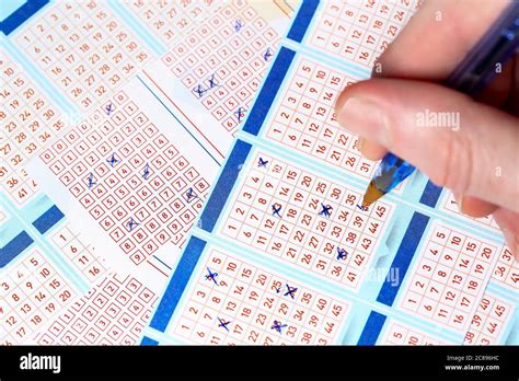 Hand With Pen Picking Numbers On Lottery Ticket Stock Photo Alamy