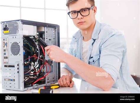Master Of Computers Portrait Of Handsome Young Man Repairing Computer While Sitting At His