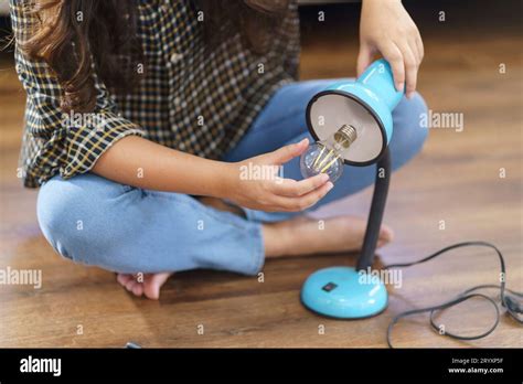 Asian Woman Changing Light Bulb In Lamp Renovation Using Equipment To Diy Repairing Light Bulb