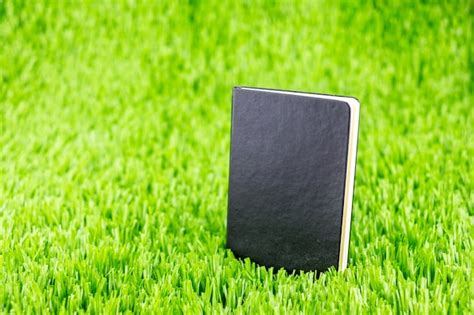 Premium Photo Open Notebook On Green Grass