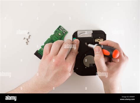The Computer Hard Drive In The Course Of Dismantling On A White Background Stock Photo Alamy