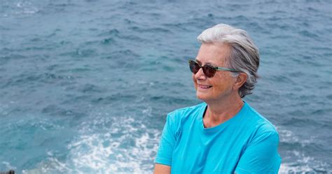 바다에서 야외 여행을 하는 노인 여성은 절벽에 앉아 물 위의 수평선을 바라보고 있다 은퇴 라이프 스타일 사진 Unsplash의 바다 이미지