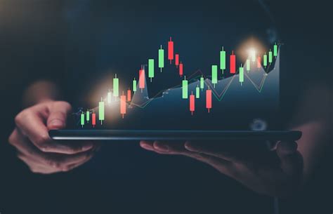 Premium Photo Stock Exchange Market Concept Hand Holding Digital Tablet With Graphs Analysis