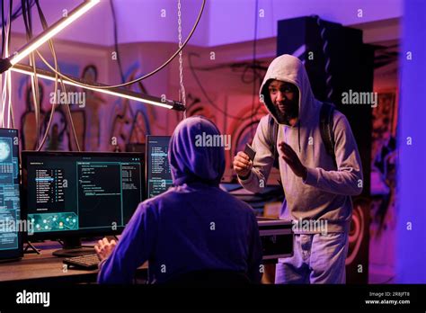 African American Hacker Holding Ssd With Illegal Malware For Password Cracking Criminal In Hood