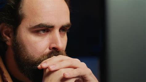 programmer in home office concentrating on finding bugs while doing