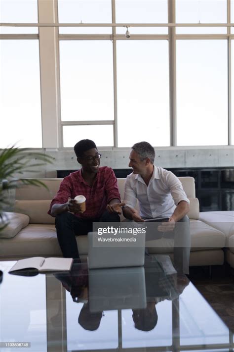 Male Executives Interacting With Each Other In Office High-Res Stock Photo - Getty Images