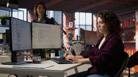 Startup Engineer Conducting Detailed Code Review To Fix Bugs Stock