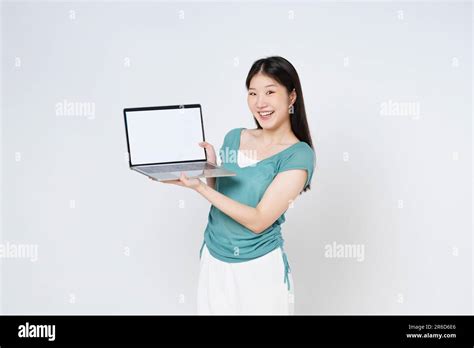 Smiling Woman Showing Blank Laptop Computer Screen Isolated Over White Background Stock Photo