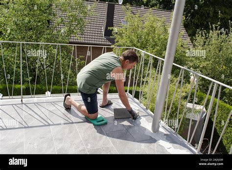 Ceramic Tiles Tiler Positioning Ceramic Floor Tiles With The Tile Leveling System Over The