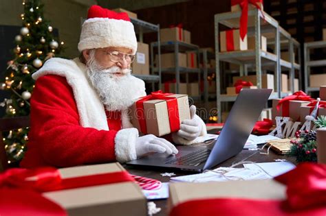 Santa Claus Using Laptop Computer Mock Up White Screen Sitting At Table Stock Image Image Of