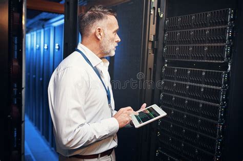It Support Are The Unsung Heroes A Mature Man Using A Digital Tablet While Working In A Server