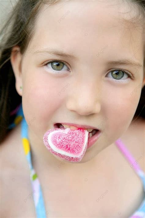 Beautiful Teen Portrait Eating A Candy Heart Bite Female Blue Photo