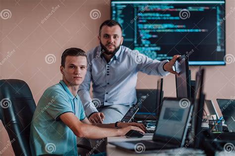 Programmers Engrossed In Deep Collaboration Diligently Working Together To Solve Complex