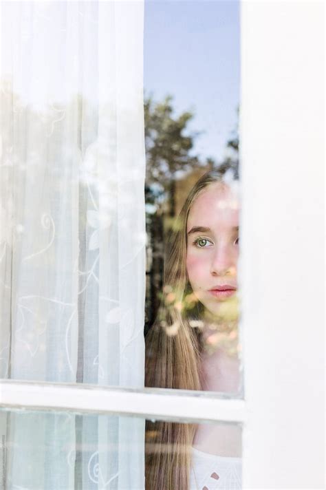 Teenage Girl At A Window With Reflections Of Outdoor Garden Del Colaborador De Stocksy Angela