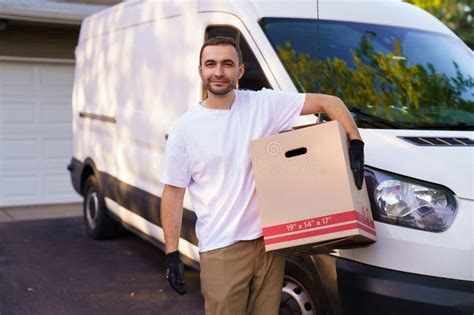 Delivery Driver Man Smiling Camera Holding Box Large Warehouse Stock