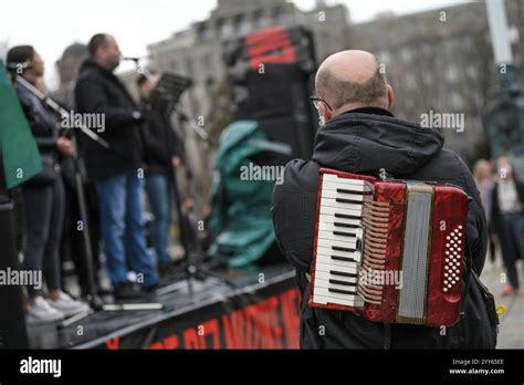 The Old Rare Red Accordion Hanging On Back Of An Accordion Musician