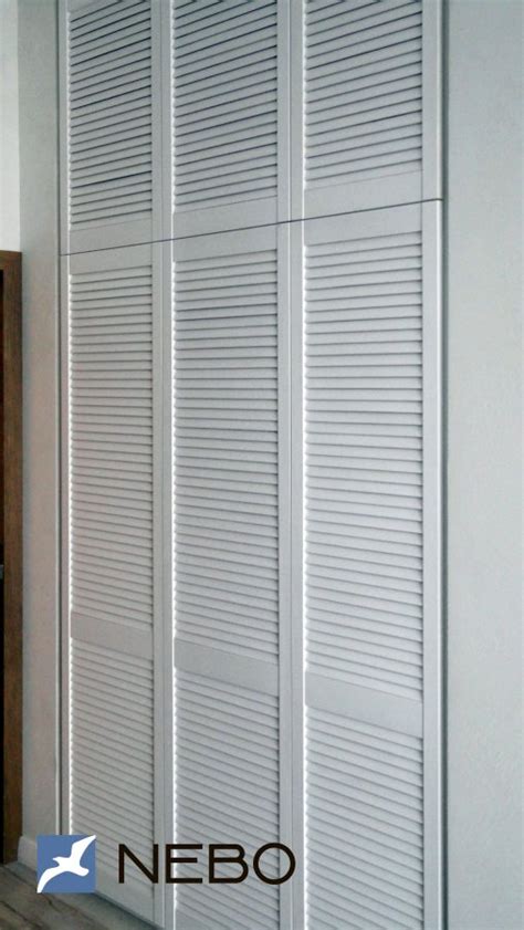 Встроенный в нишу жалюзийный шкаф белого цвета до потолка на заказ в Москве