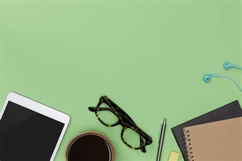 사무실 용품의 창조적 인 평면 누워 녹색 배경에 고립 된 태블릿 책 및 액세서리 복사 공간이있는 상단보기 프리랜서 개념을위한 작업 공간 개념에 대한 스톡 사진 및 기타