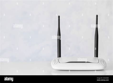 Modern Wi Fi Router On Table Near White Wall Stock Photo Alamy