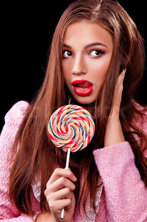Young Girl Sucks Sweet On Stick Stock Image Colourbox