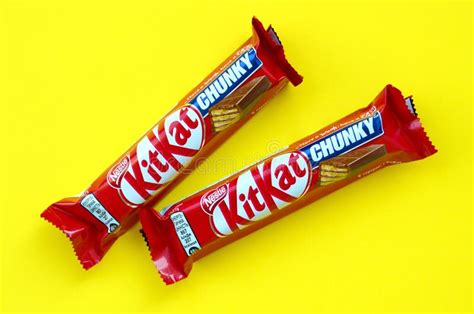 Kit Kat Chocolate Bars In Red Wrapping Lies On Bright Yellow Background