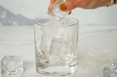 Individual Dropping Ice Cubes Into A Highball Glass Stock Image Image