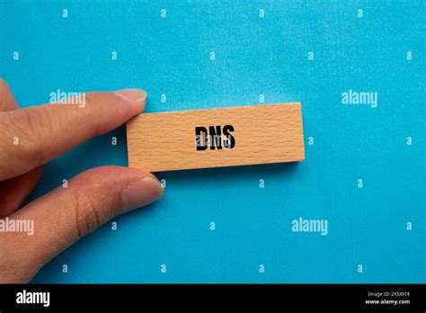 Dns Word Written On Wooden Block With Blue Background Conceptual Dns Symbol Copy Space Stock