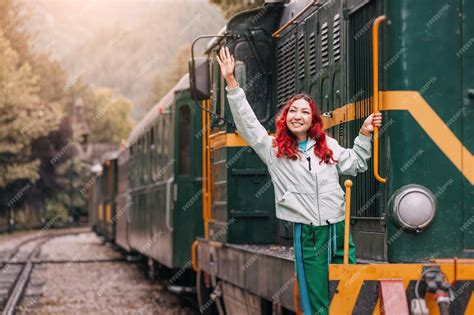 Premium Photo Young Woman Waving Goodbye From The Vintage Train Ready