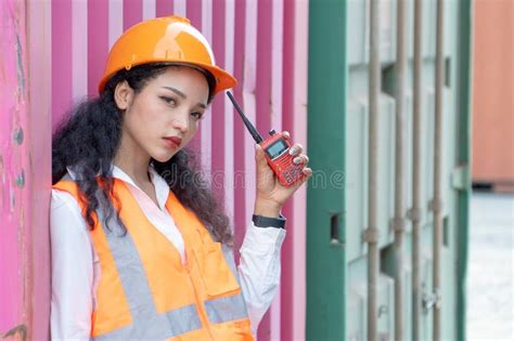 Portrait Of Female Worker In Cargo Containers In Shipping Container Yard Woman Holding Walkie