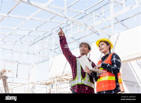 Asian Engineer Foreman Worker Man And Woman Working At Building