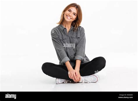 Portrait Of A Smiling Lovely Girl Sitting And Looking At Camera
