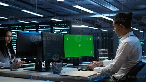System Administrator Overseeing Data Center Using Green Screen Computer Ensuring System Can