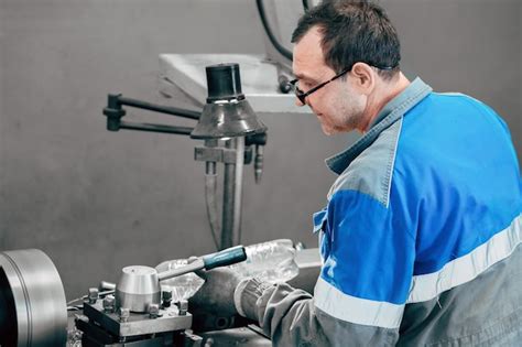 Premium Photo Turner In Overalls Works At Lathe In Turning Shop At